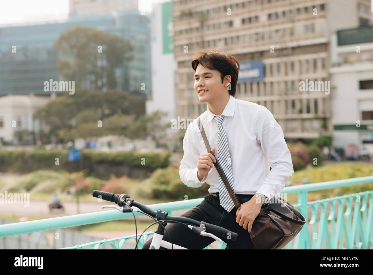 Successful businessman riding bicycle Stock Photo - Alamy