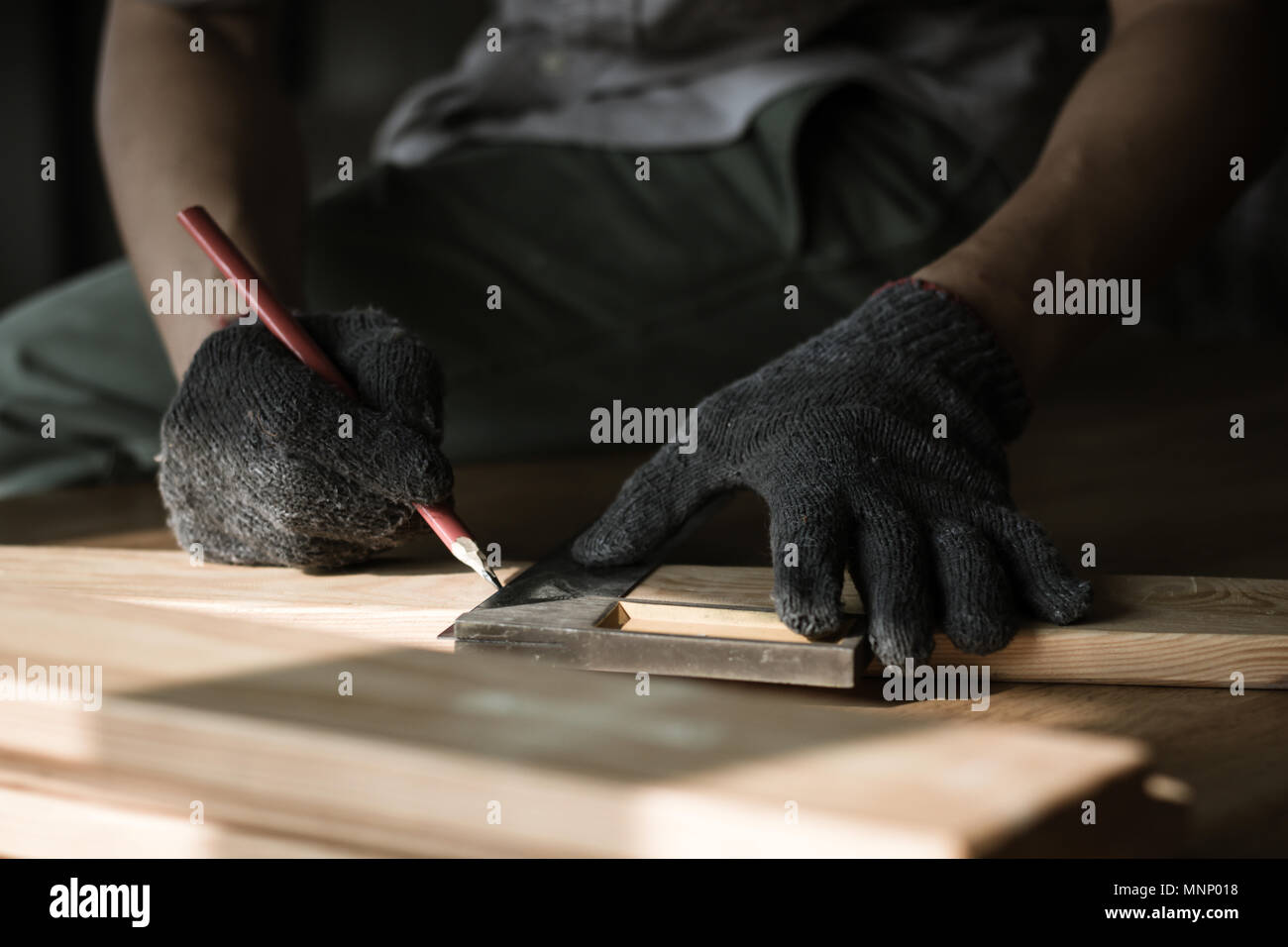 carpenter measuring and writing on wood with copy space background ...