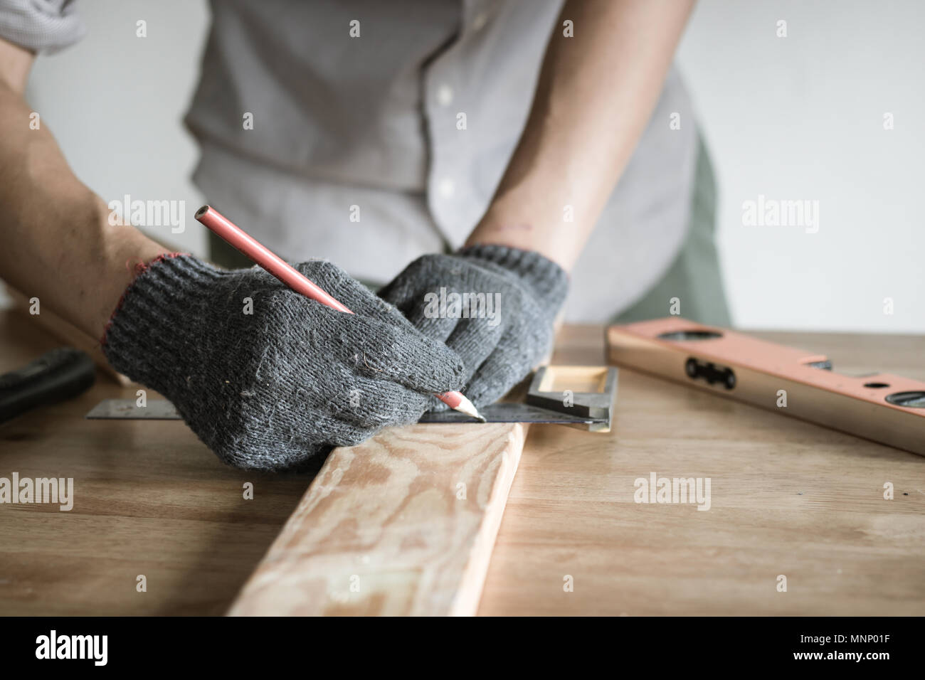 carpenter measuring and writing on wood with copy space background ...
