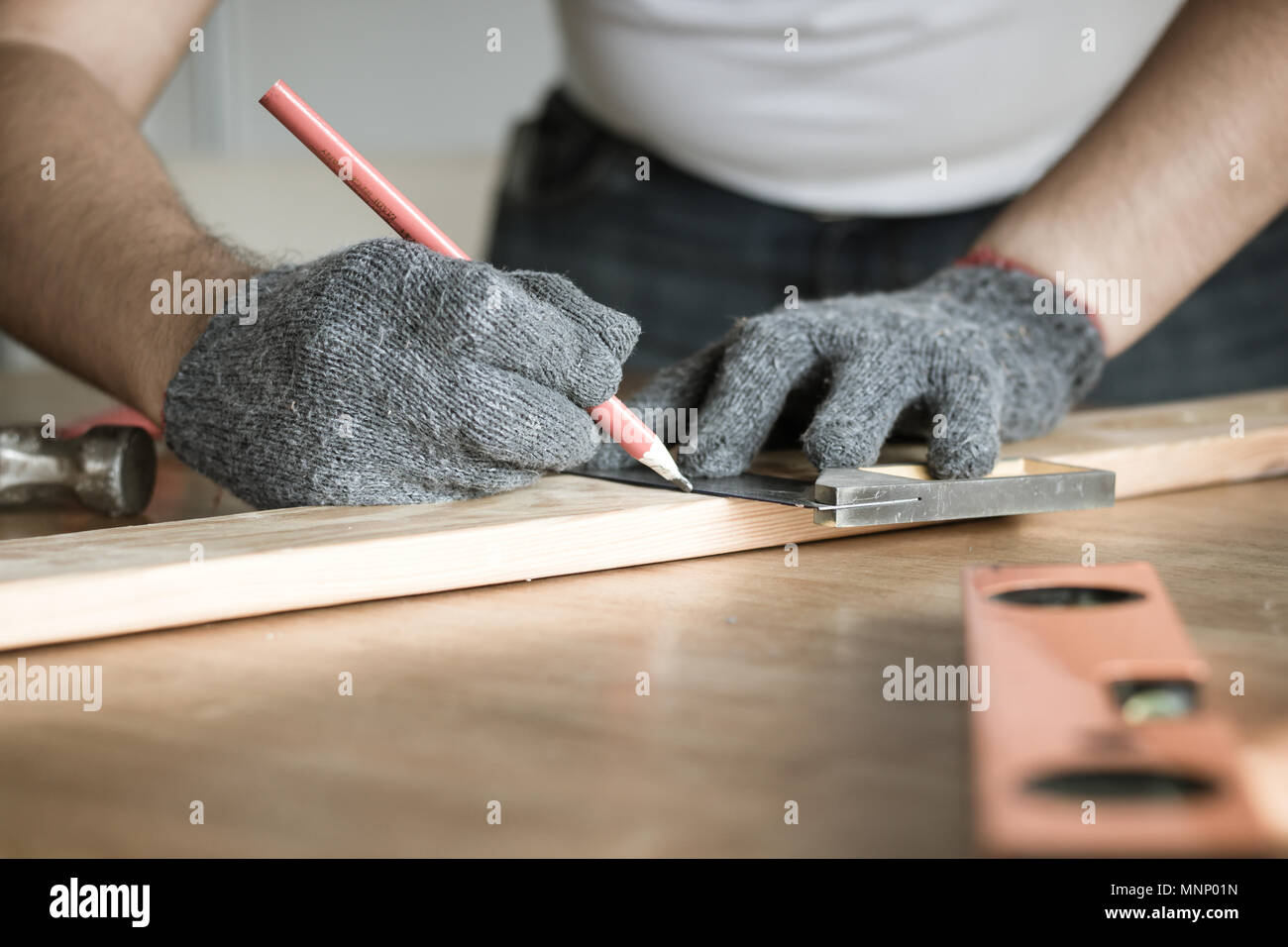 carpenter measuring and writing on wood with copy space background ...