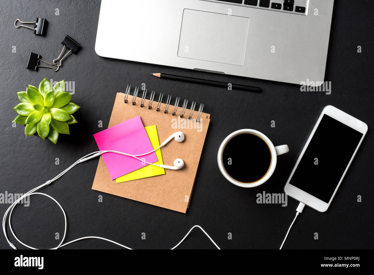 Black office desktop with laptop and accessories Stock Photo - Alamy