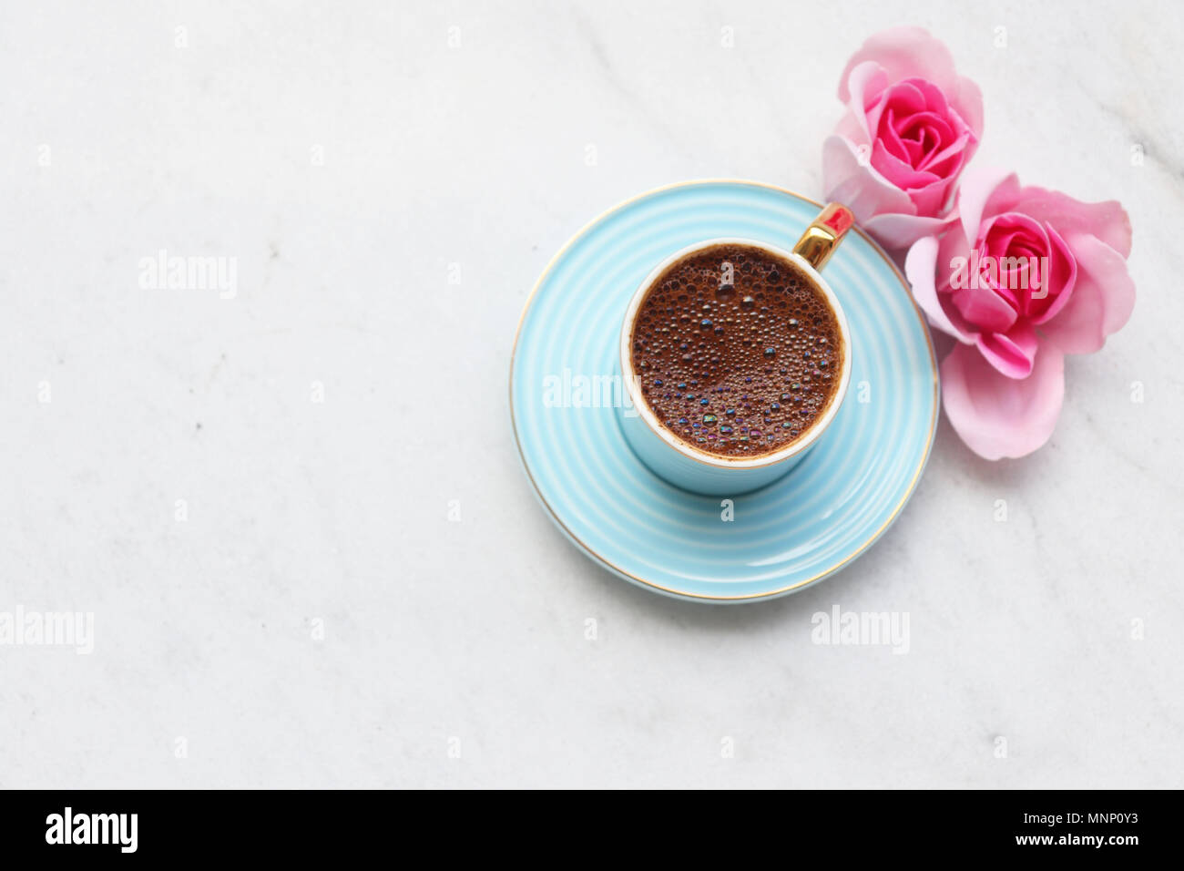 blue cup of coffee with flower on white background Stock Photo - Alamy