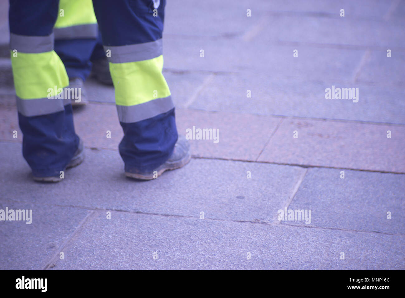 Municipal workers on sidewalk pavement standing in work uniform with ...