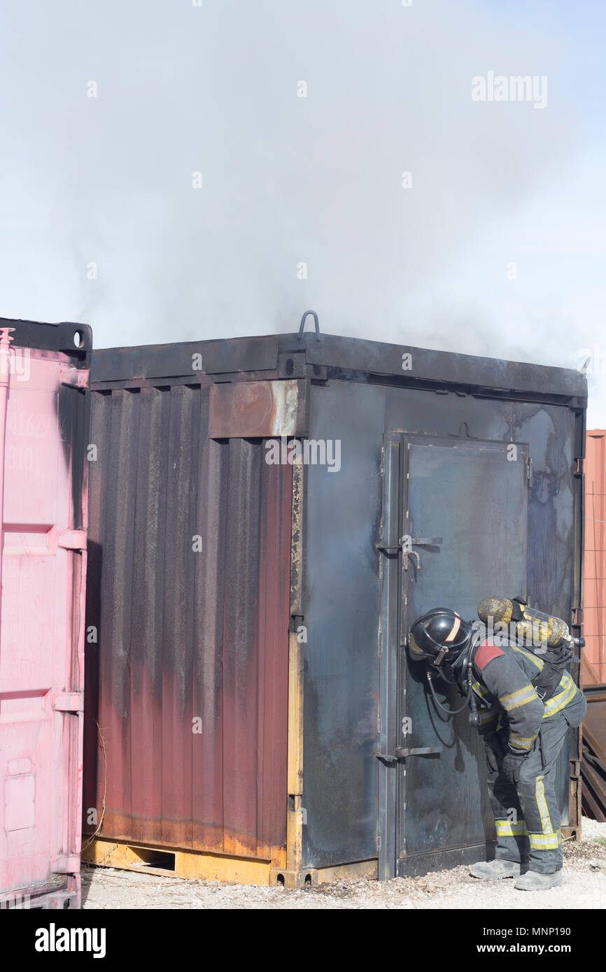 Firefighter putting out fire training station extinguisher backdraft ...