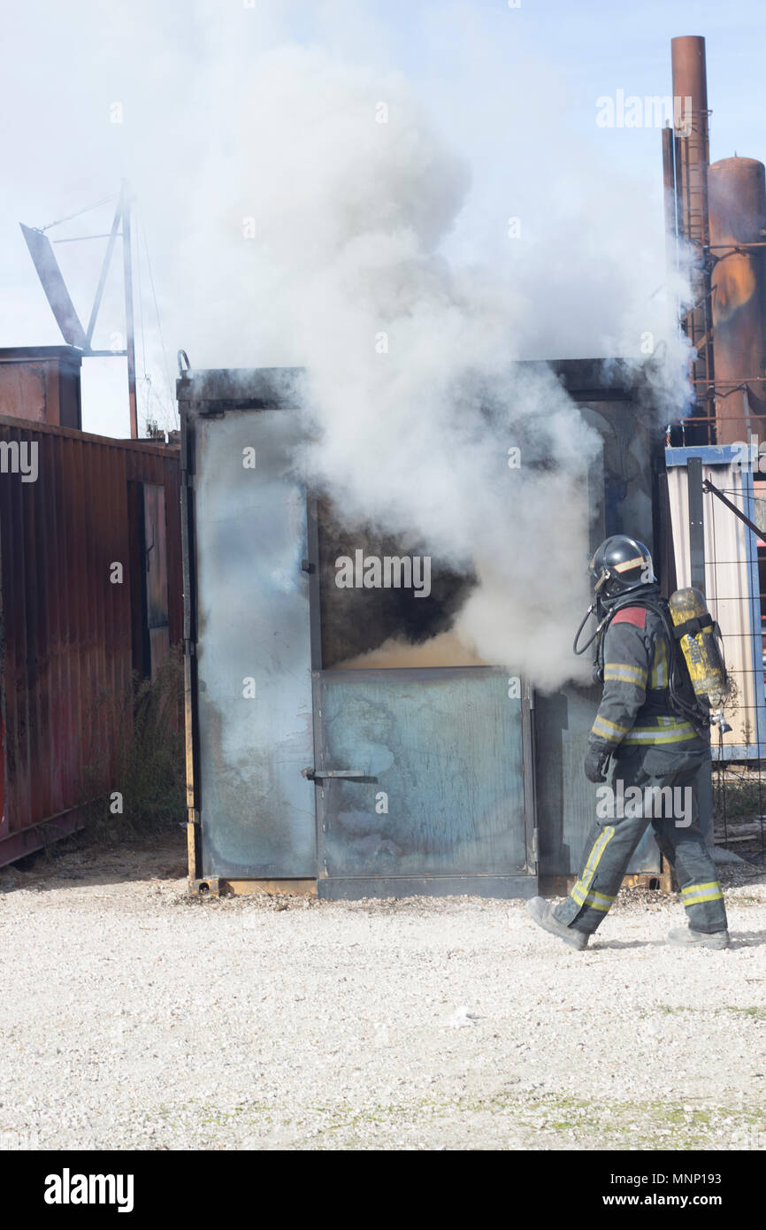 Firefighter putting out fire training station extinguisher backdraft ...