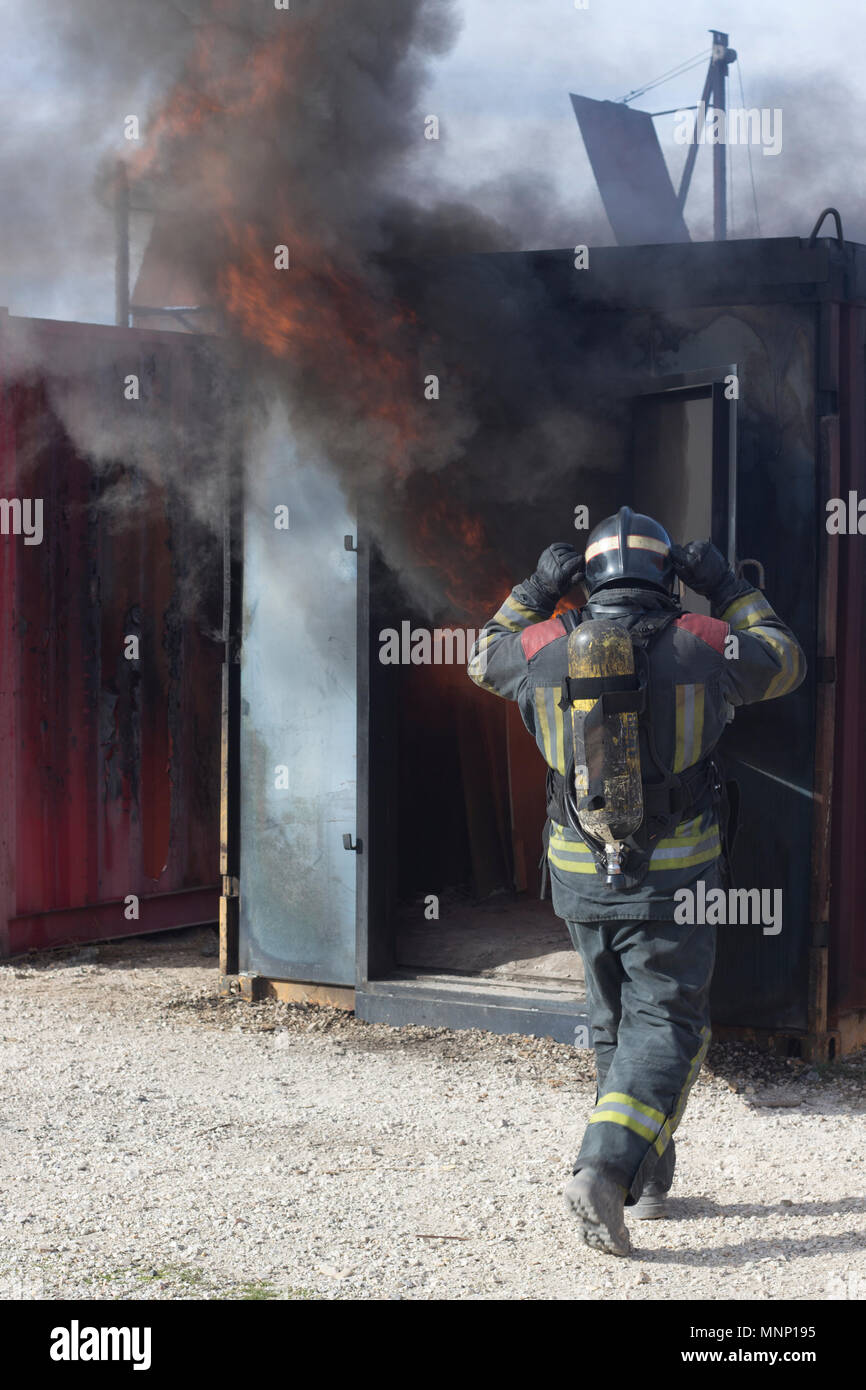 Firefighter putting out fire training station extinguisher backdraft ...