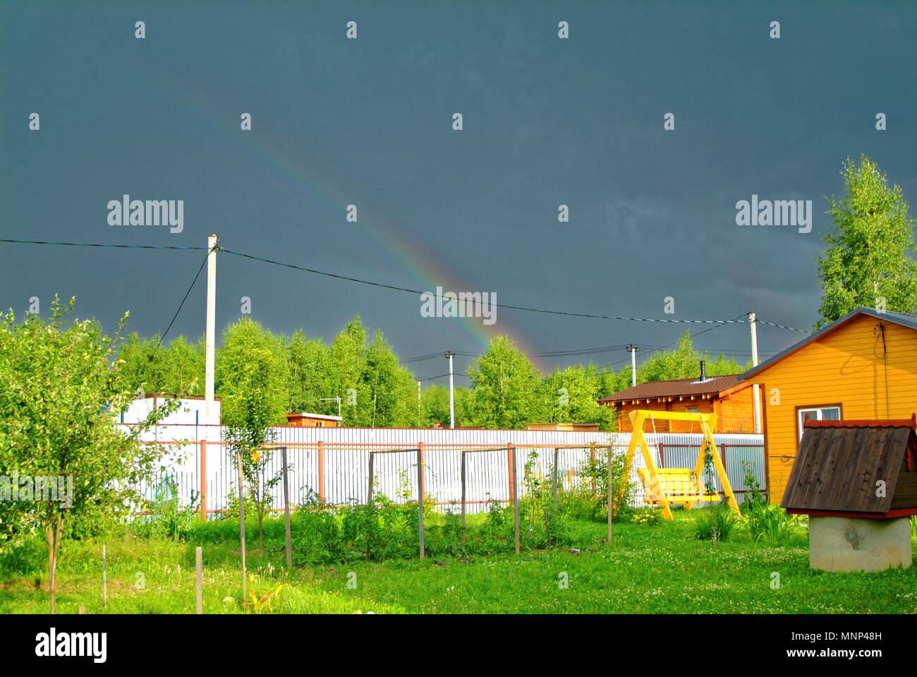 rainbow in the storm sky, rural area in Russia Stock Photo - Alamy