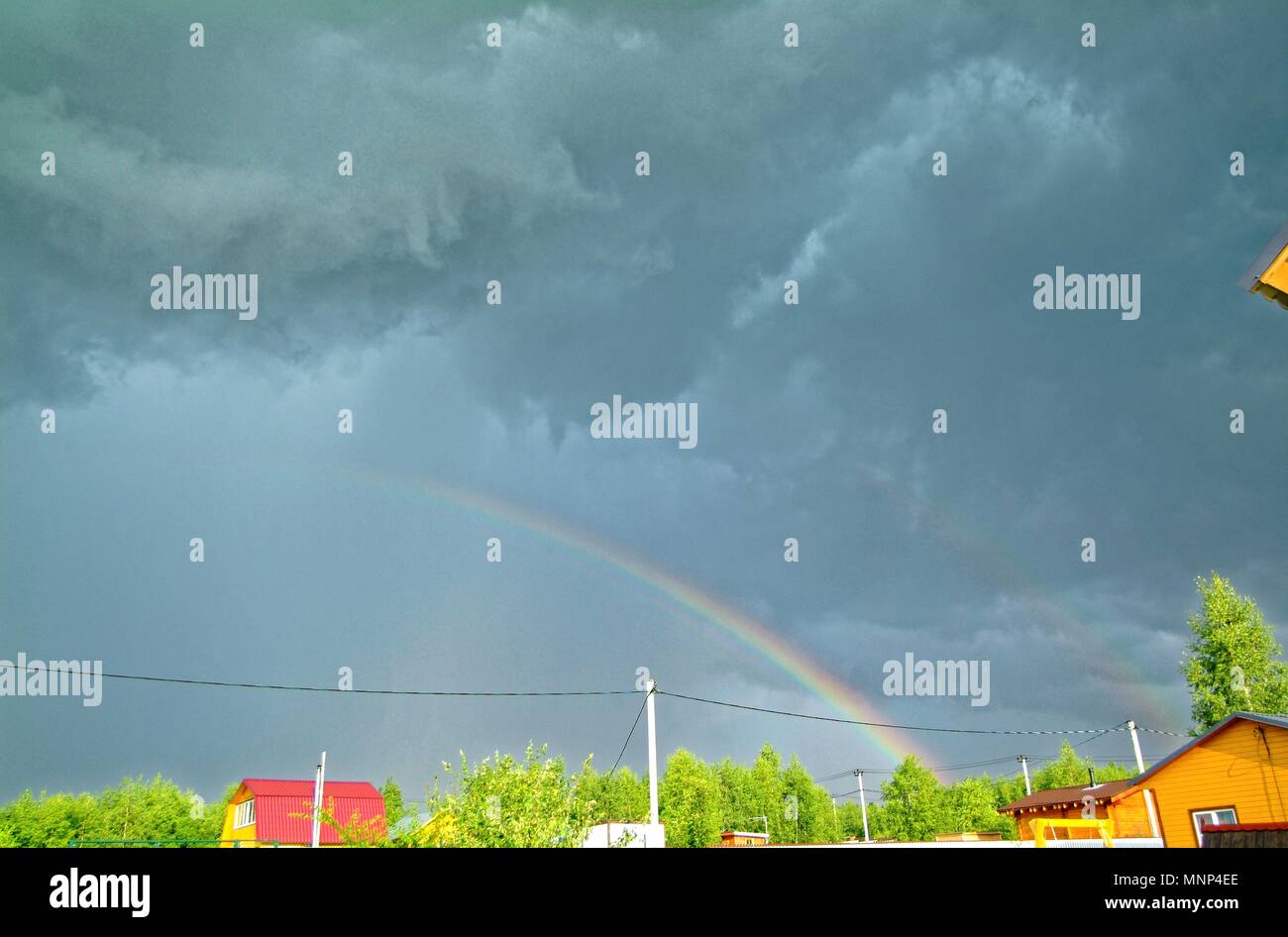 rainbow in the storm sky, rural area in Russia Stock Photo - Alamy