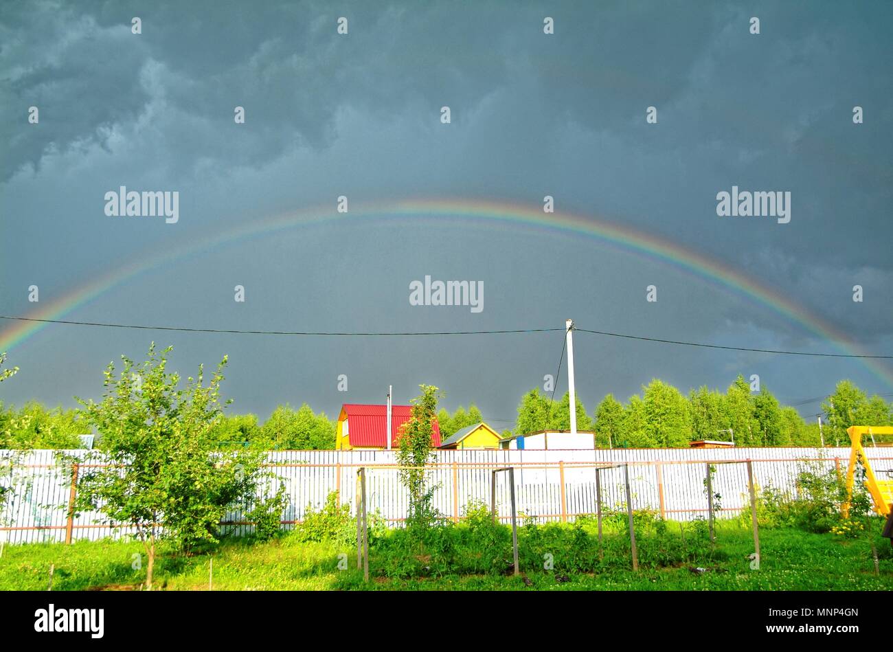 rainbow in the storm sky, rural area in Russia Stock Photo - Alamy