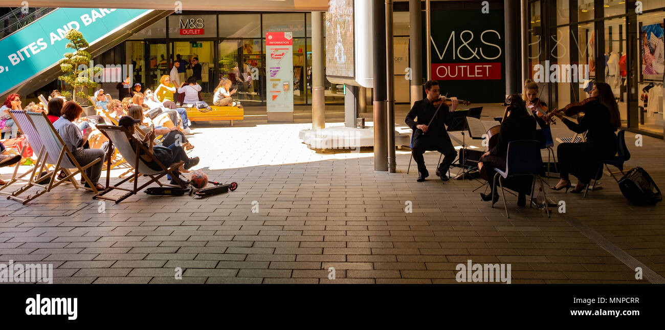 London, England, 19th May 2018. A string quartet play wile a crowd ...