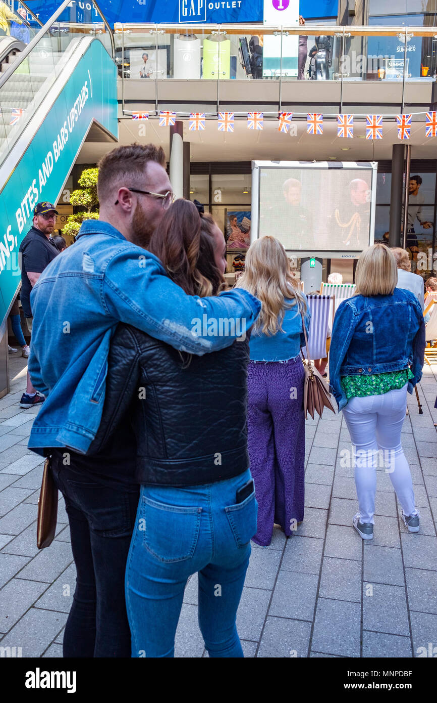 London, England, 19th May 2018. A couple embrace in a crowd watching ...