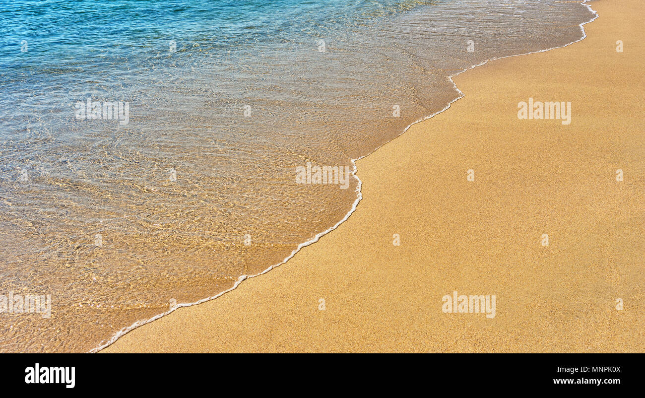 Sea beach. Waves and sand on a tropical beach Stock Photo - Alamy