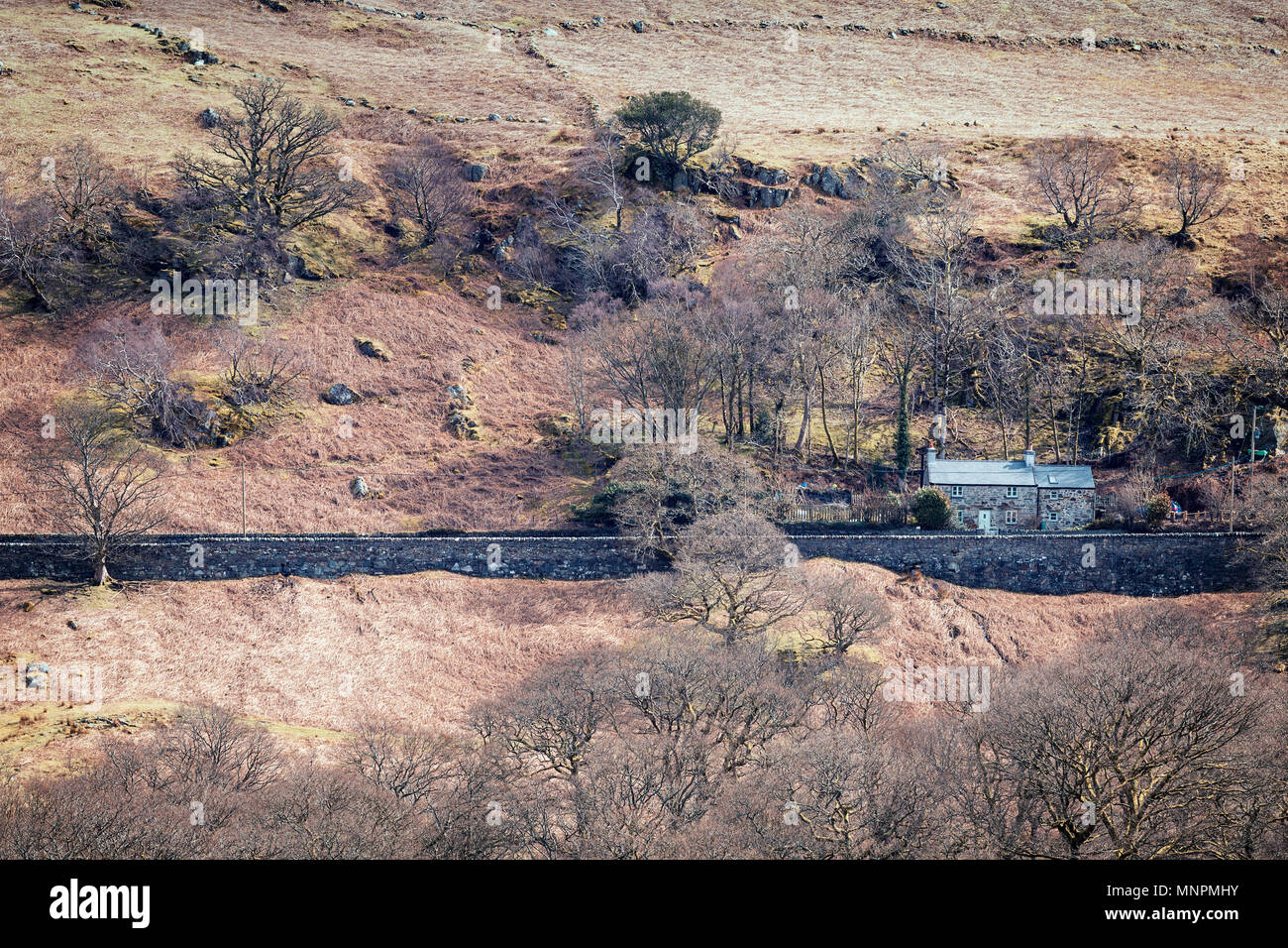 Slopes of Ogwen Valley at early spring with stone build road and old ...