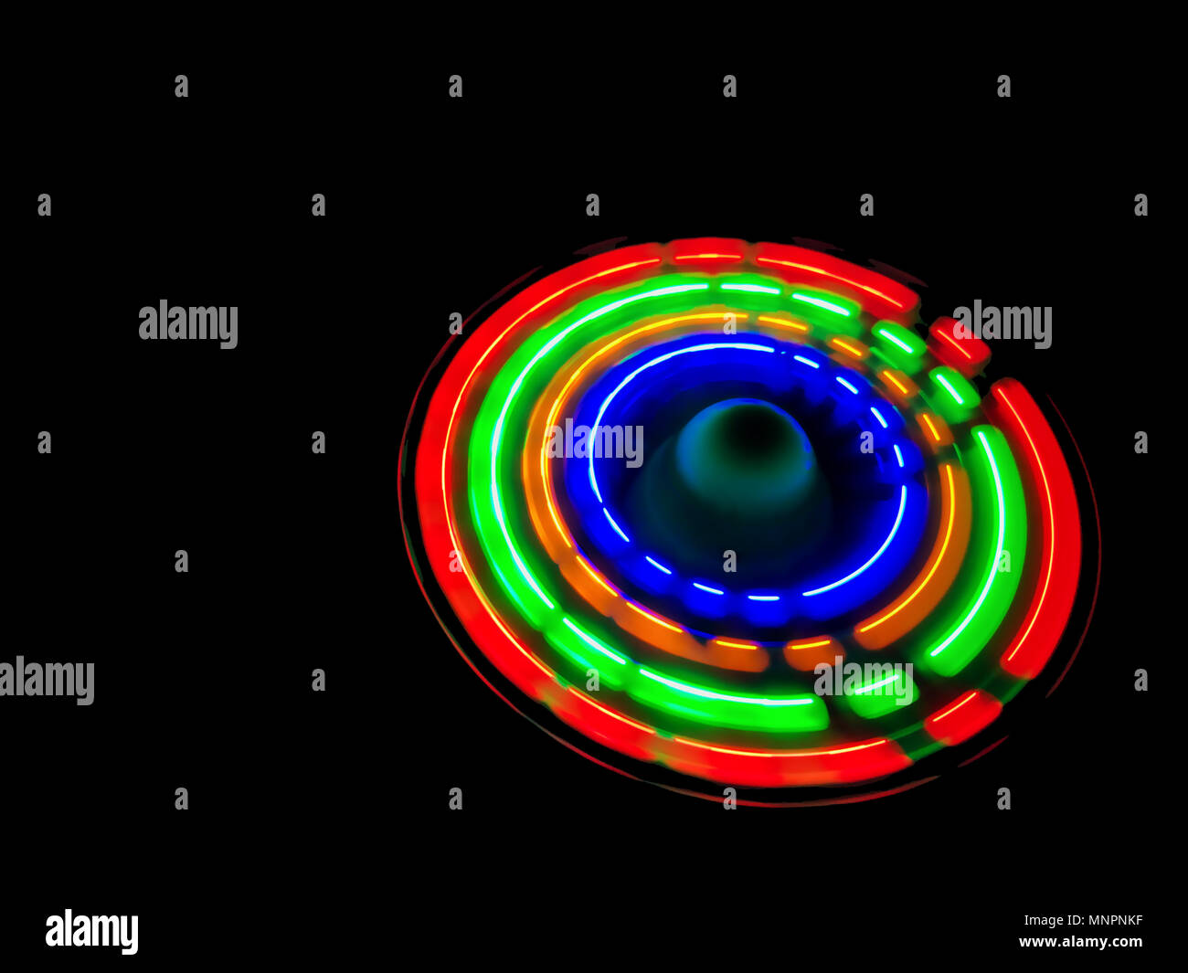 Neon Spinning toy in the dark Stock Photo - Alamy