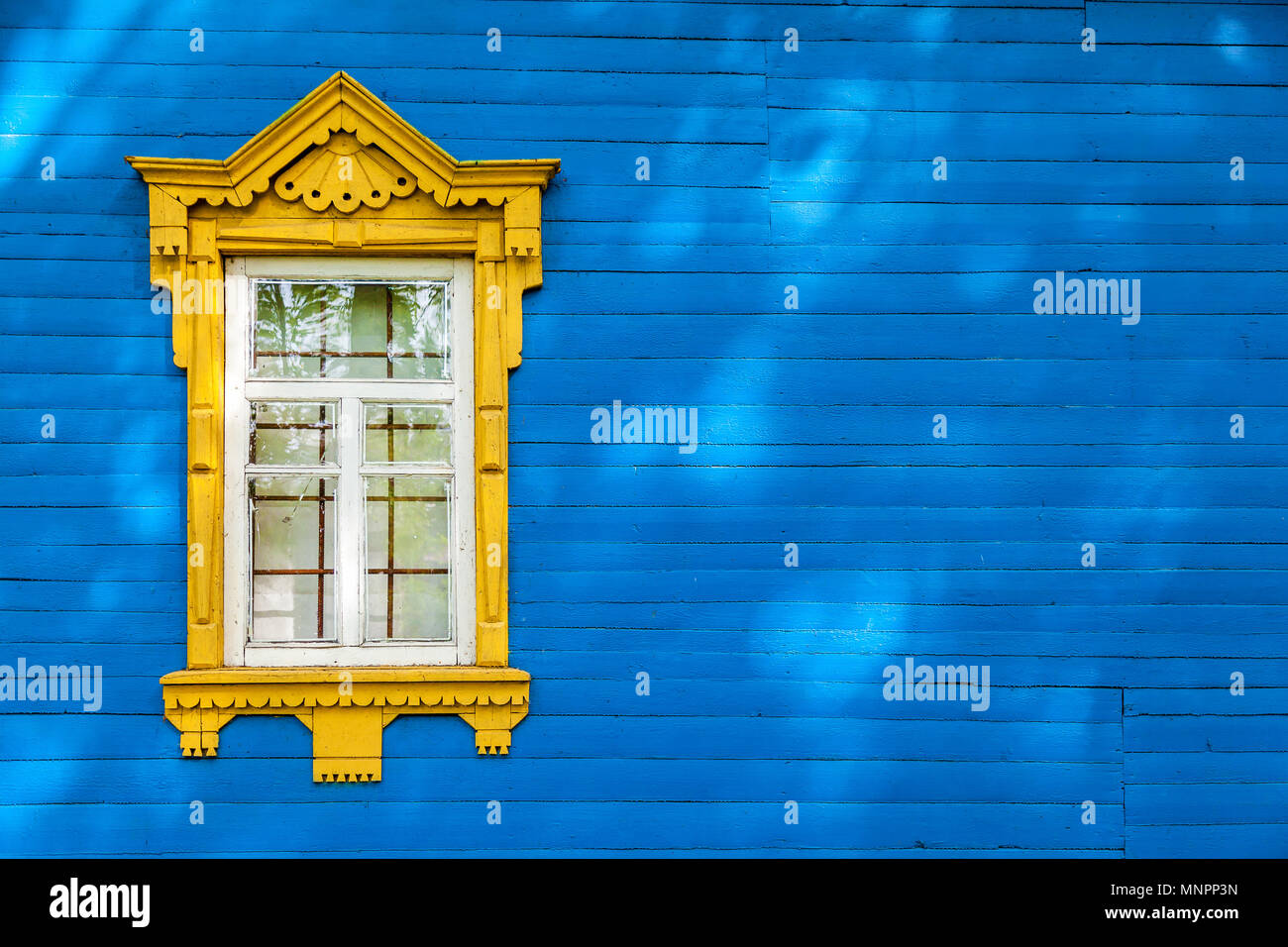 Vintage yellow window on a blue wooden wall Stock Photo - Alamy