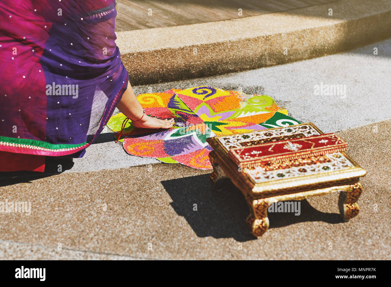 Women coloring tradition colorful rice art or sand art (Rangoli) on the ...