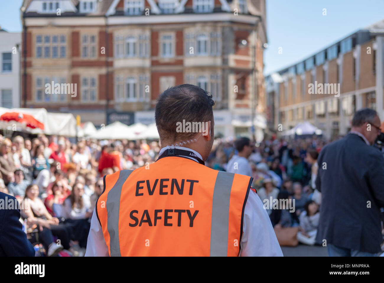 Shallow focus of an Event Safety officer seen facing members of the ...