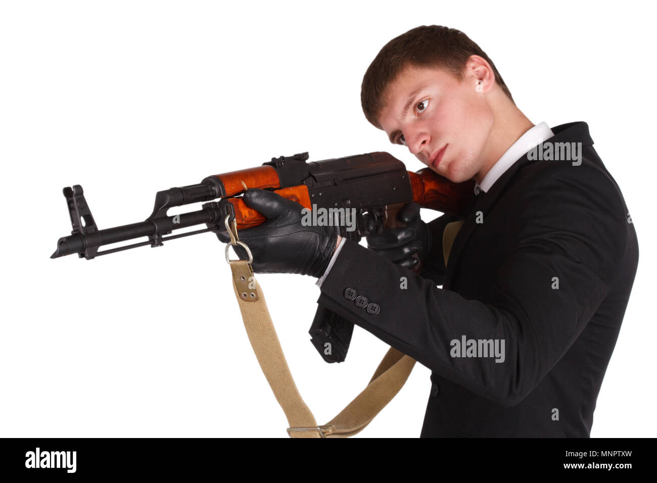 man in black suit and ak 47 isolated on white Stock Photo - Alamy