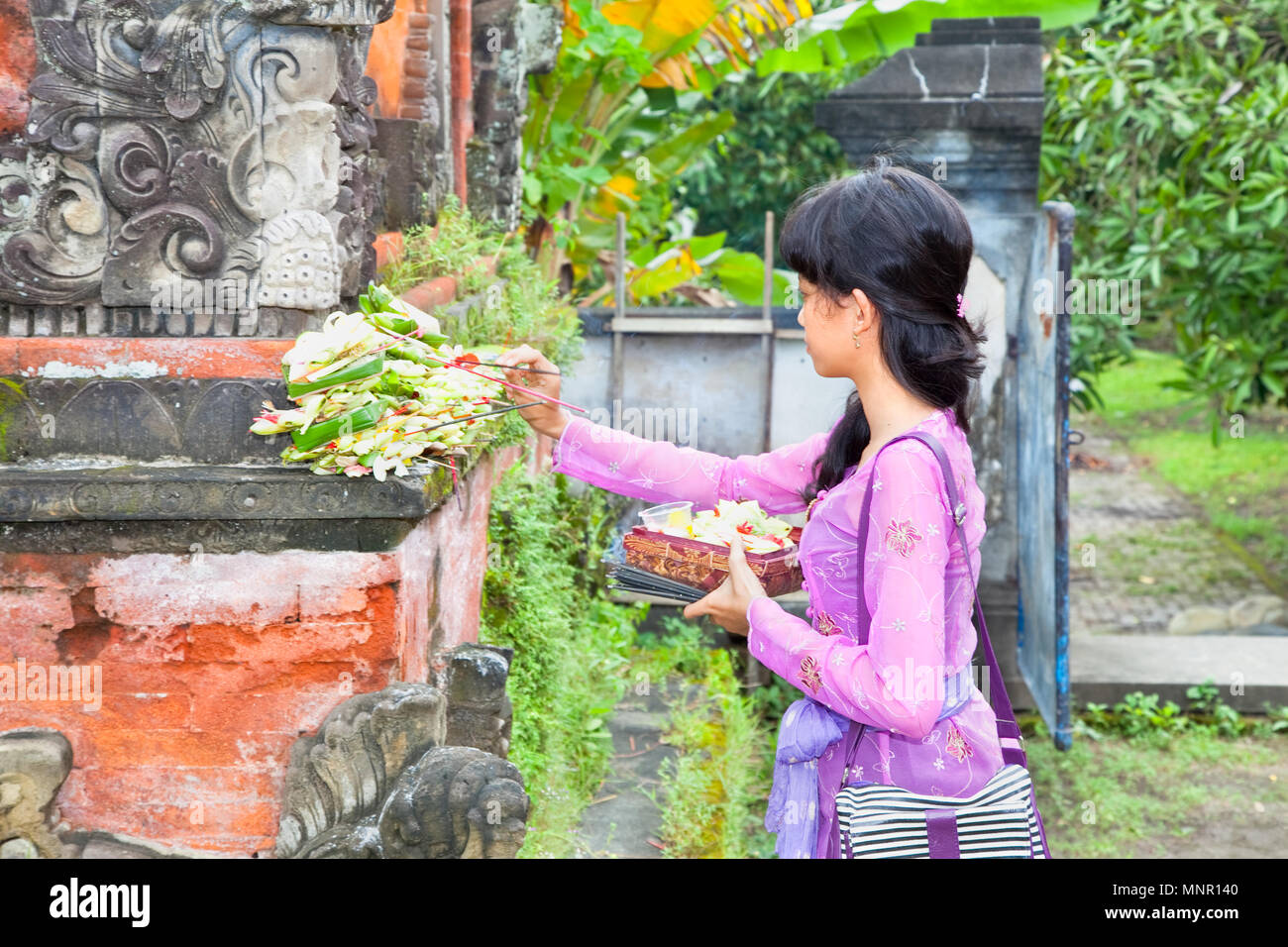 LOMBOK- FEBRUARY 1: Young Hindu lady prays in a Mayura temple February ...