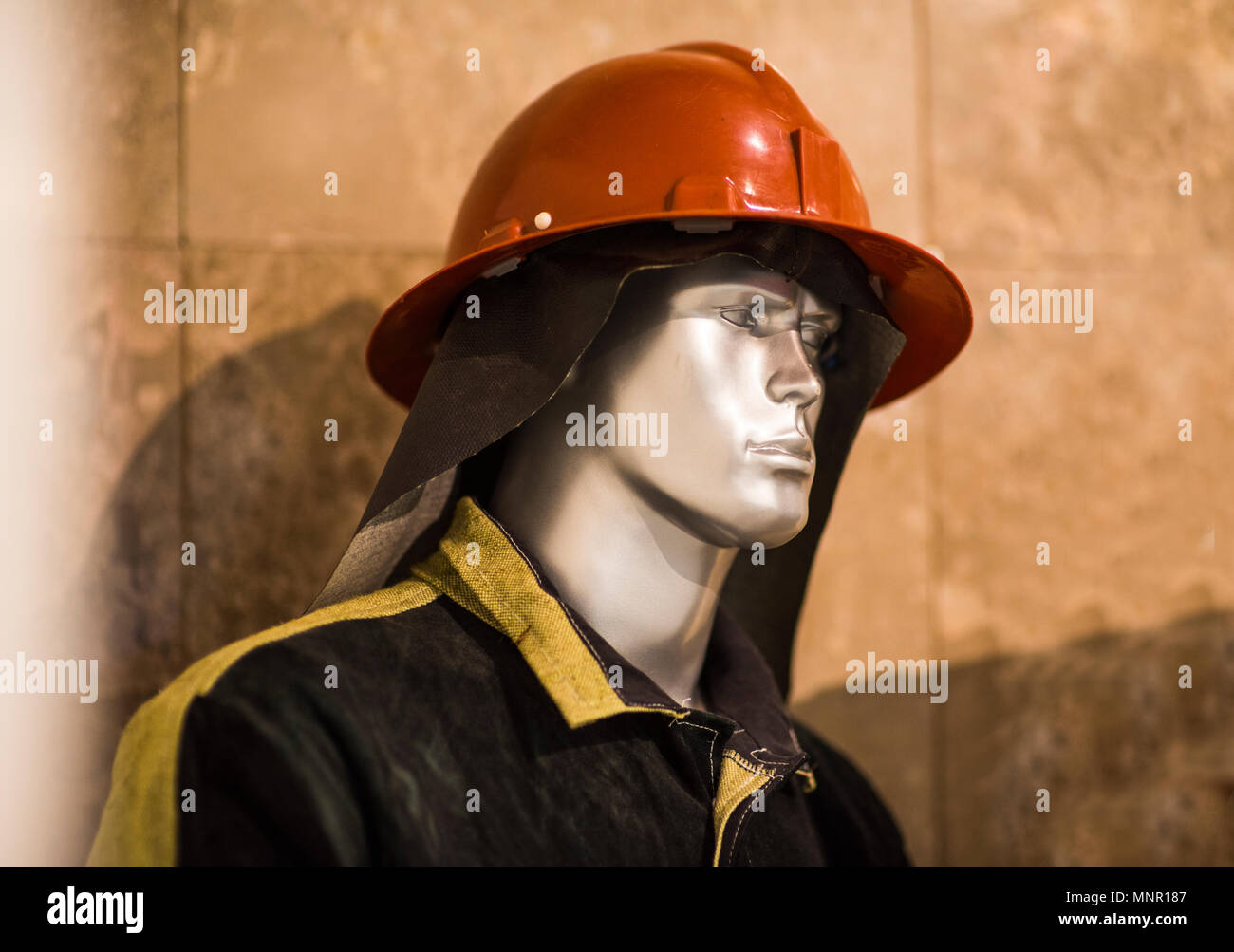 Exhibition firefighter dummy in fire fighter helmet and uniform ...
