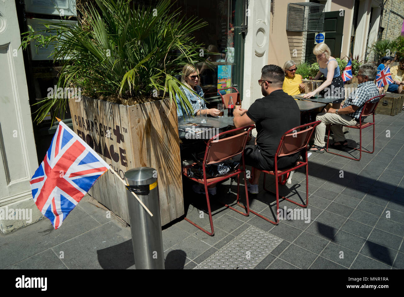 Tourists at a pub with Union Jack flags in Greenwich, London during ...