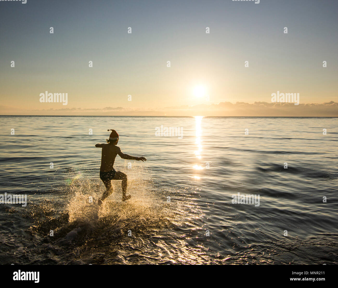 Young woman jumping in sea hi-res stock photography and images - Alamy