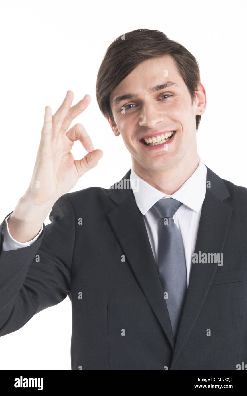 Everything is OK! Happy young business man in suit and tie gesturing OK ...