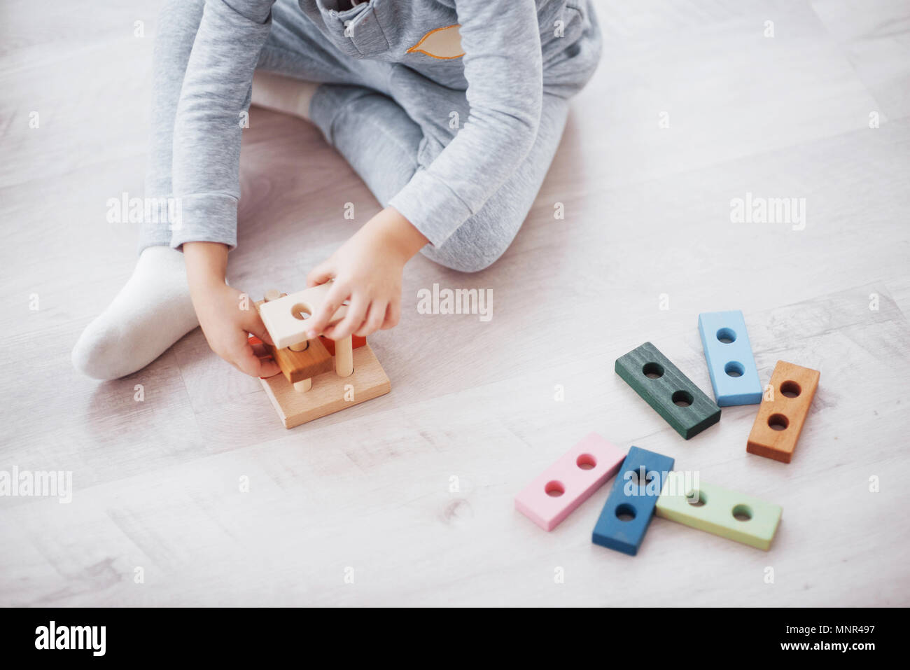 Children play with a toy designer on the floor of the children's room ...