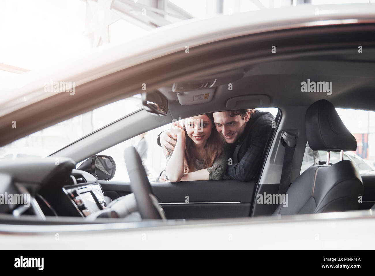 Making their decision. Beautiful loving couple sitting in a new car ...