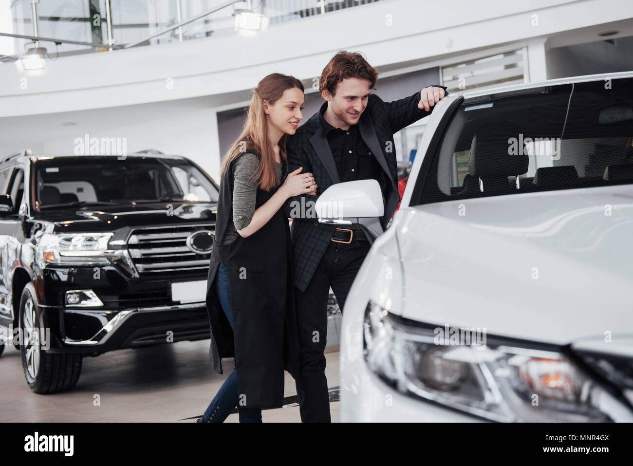 Proud owners. Beautiful young happy couple hugging standing near their ...