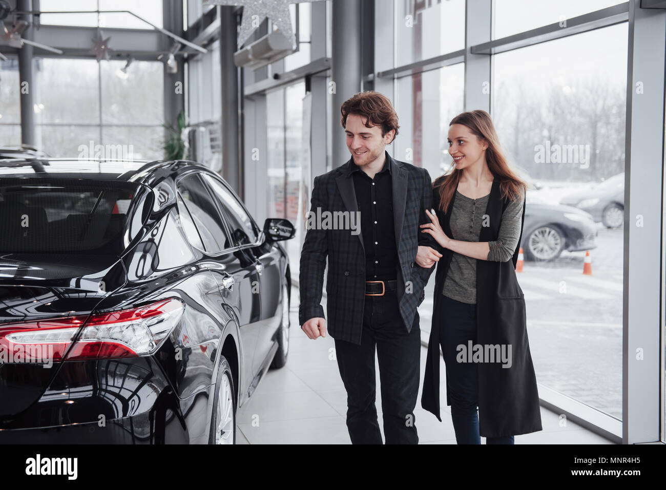 Proud owners. Beautiful young happy couple hugging standing near their ...
