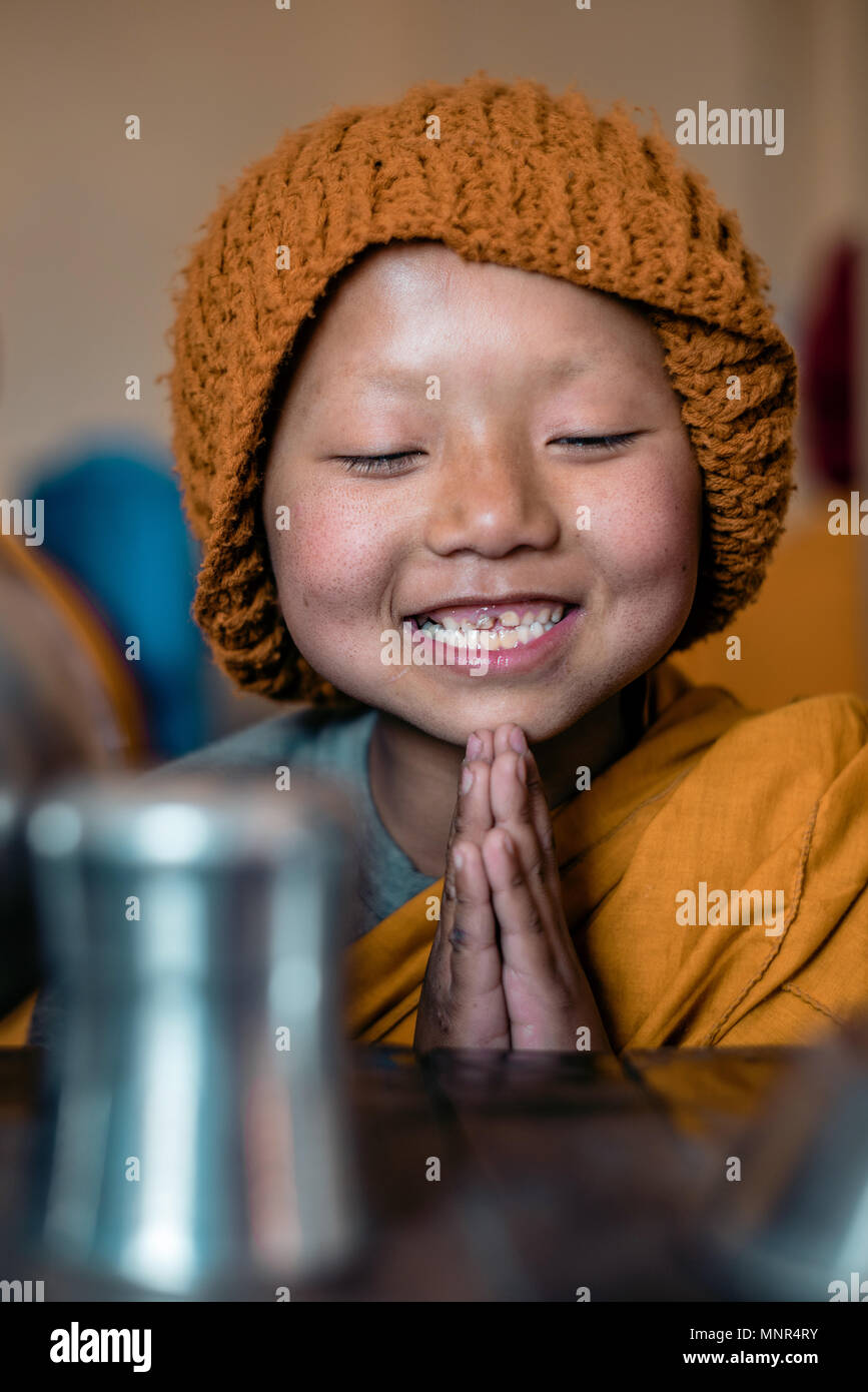 Buddhist child praying with positive smile and faith Stock Photo - Alamy