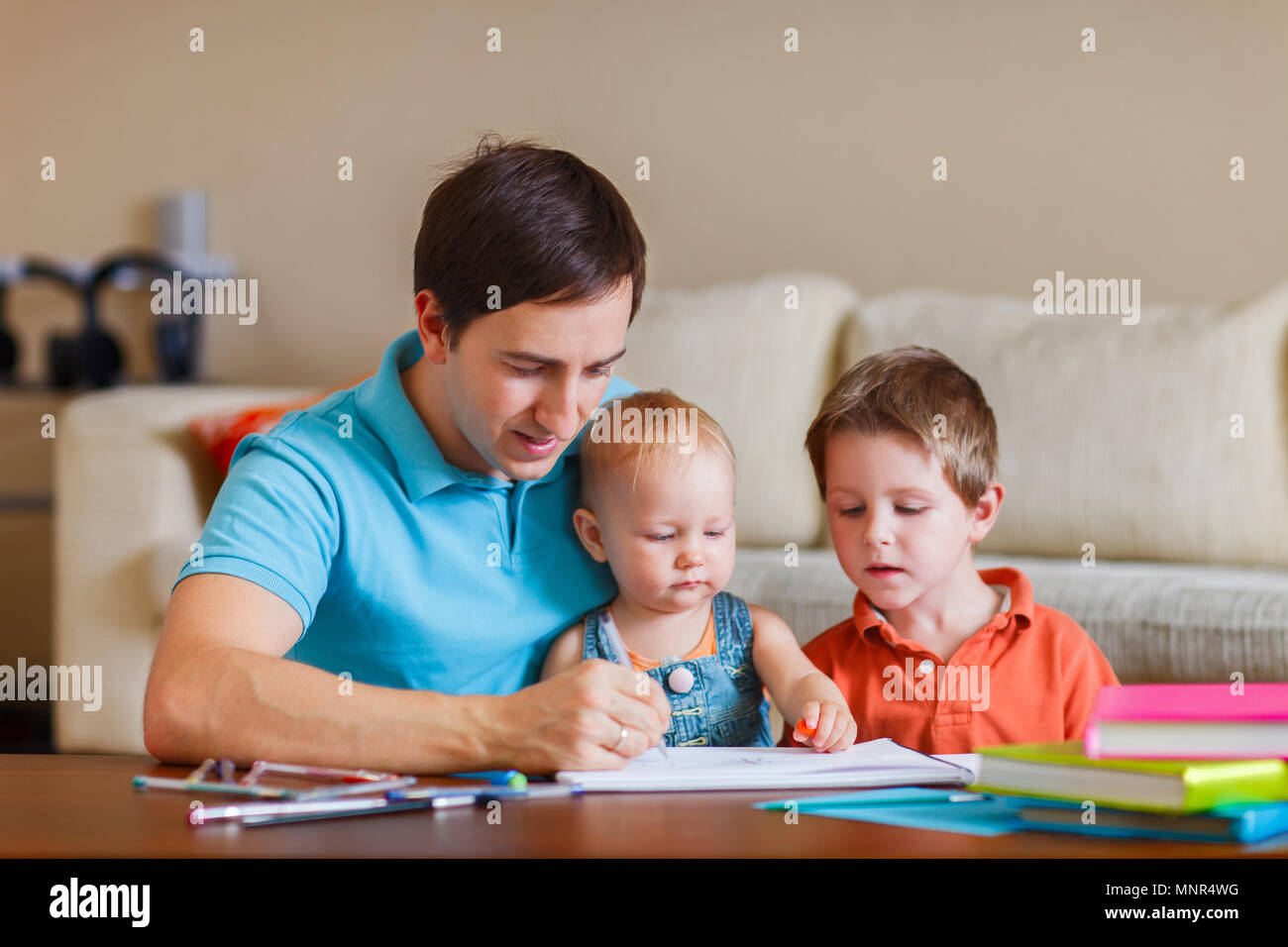 Father and his two kids drawing together Stock Photo - Alamy