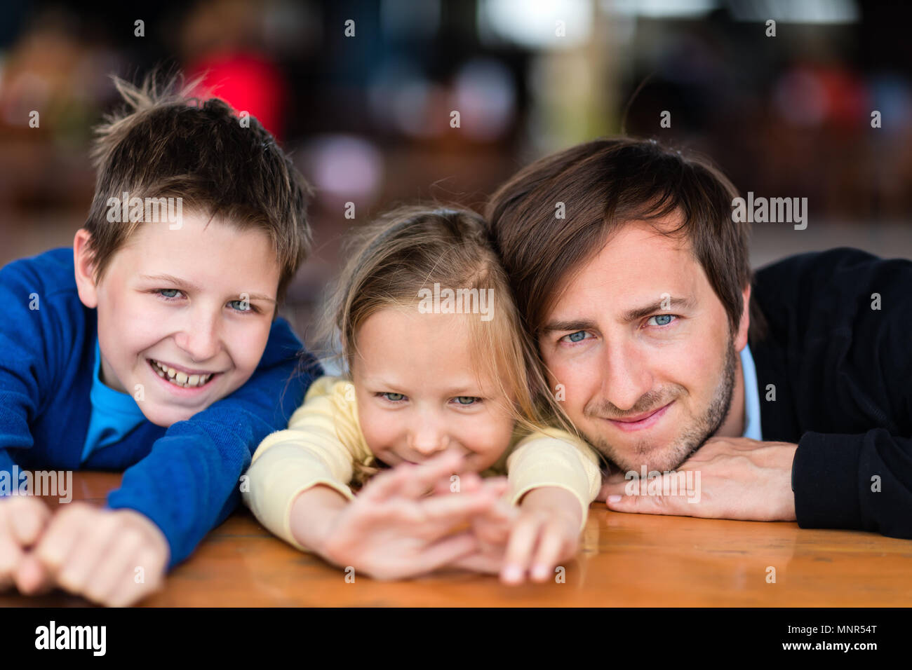 Happy family of father and two kids outdoors Stock Photo - Alamy