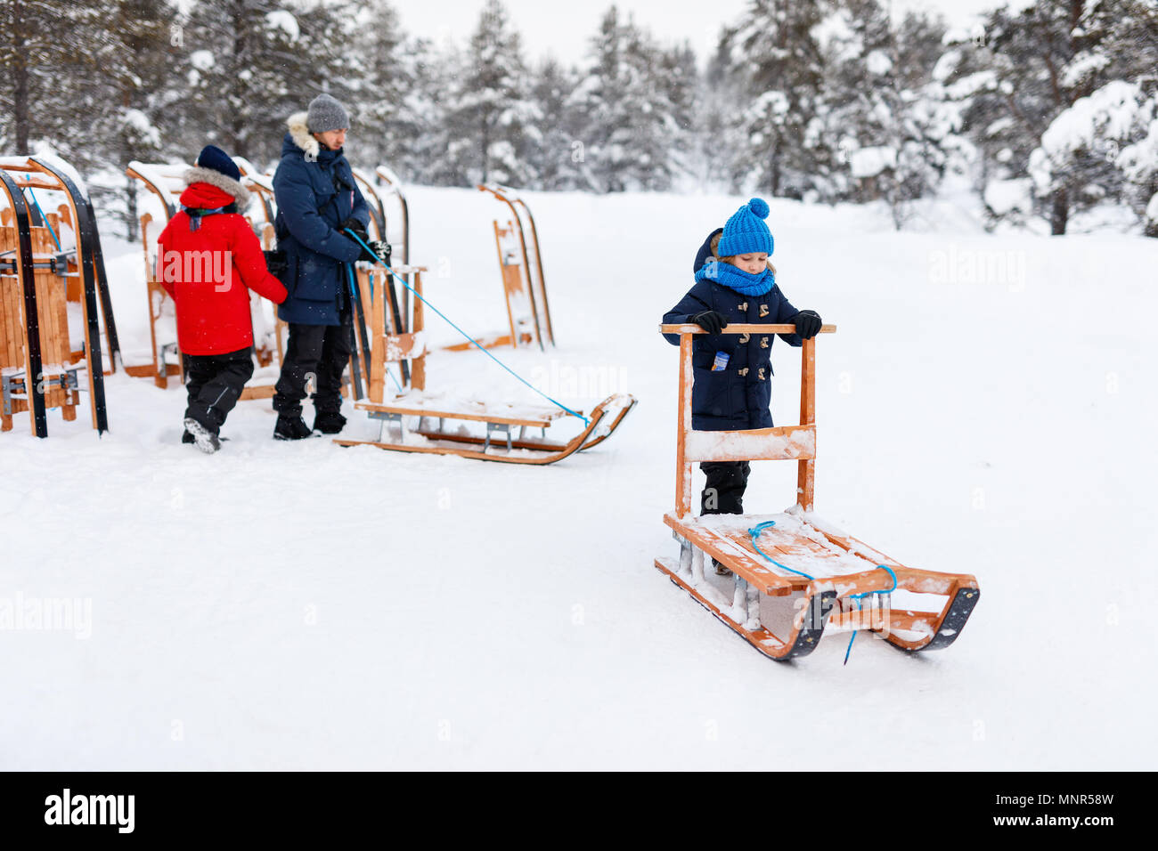 Beautiful family of father and kids enjoying snowy winter day outdoors ...