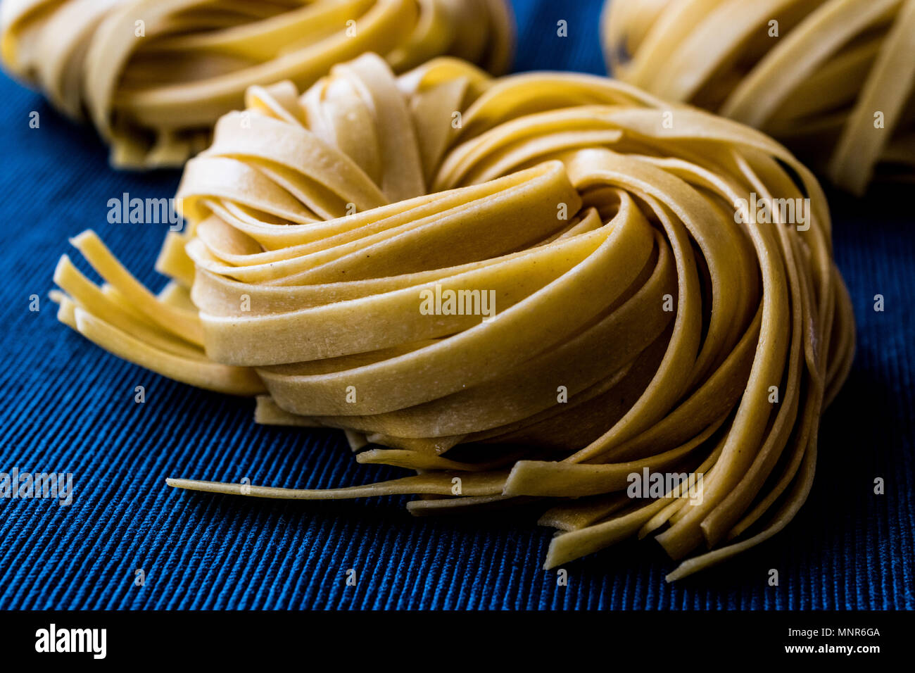 Raw Tagliatelle / Uncooked Pasta or Spaghetti. Raw food concept Stock ...