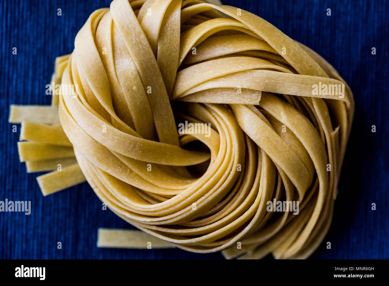 Raw Tagliatelle / Uncooked Pasta or Spaghetti. Raw food concept Stock ...