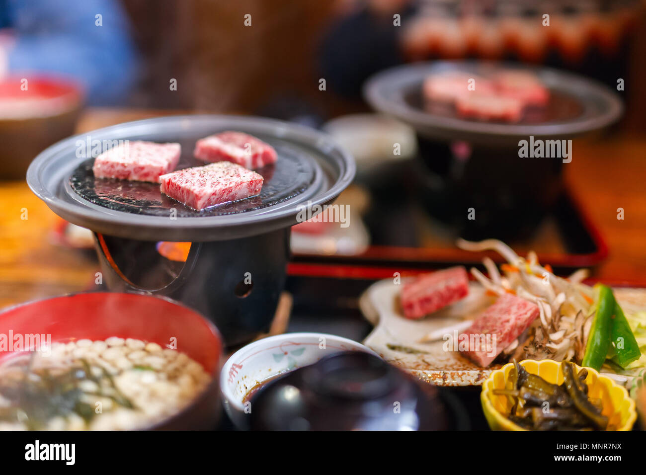 Traditional Japanese lunch with hida beef prepared on grill Stock Photo ...