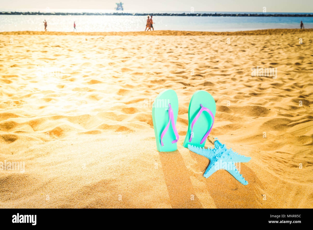 Summer beach fun - summer blue sandals with starfish in beach sand ...