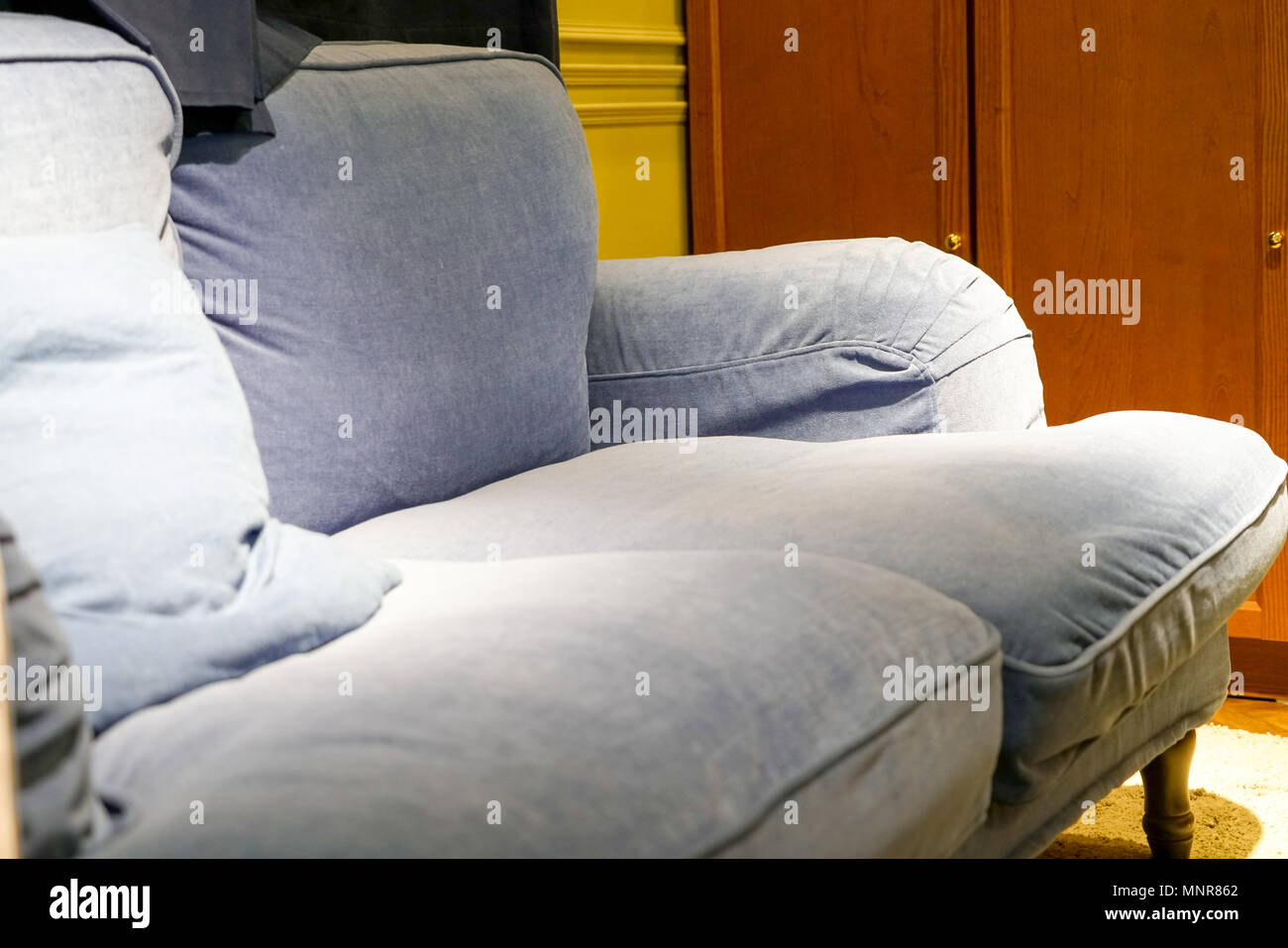 blue-jean sofa sitting on the home corner Stock Photo - Alamy