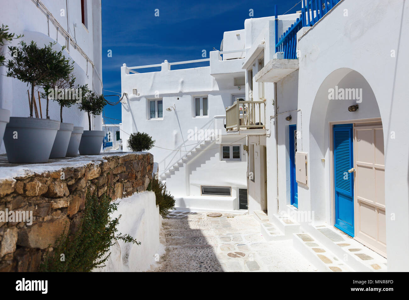 Typical street of greek traditional village with white walls and ...