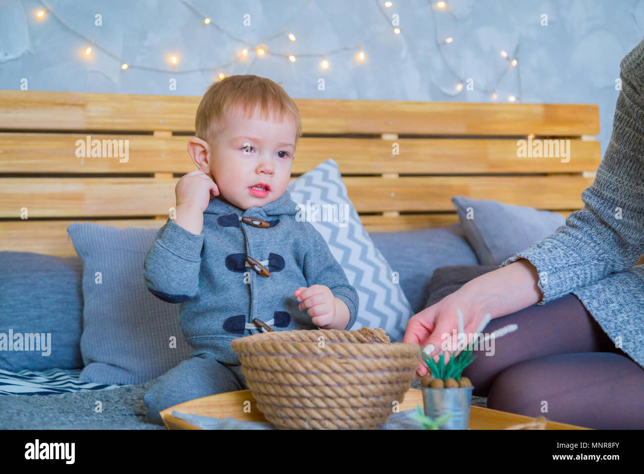 Happy young mother and her baby son playing with walnuts Stock Photo ...