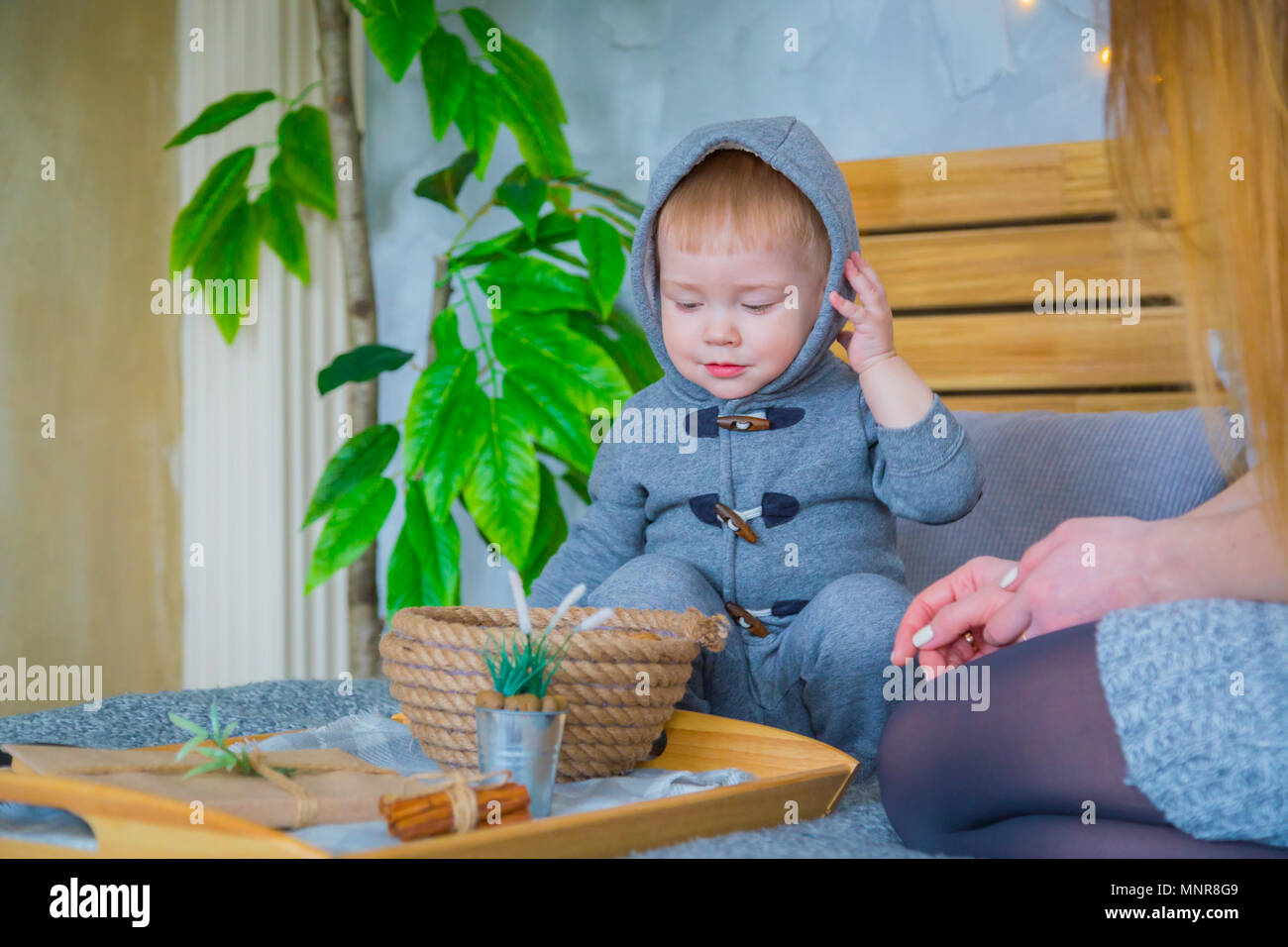 Happy young mother and her baby son playing with walnuts Stock Photo ...