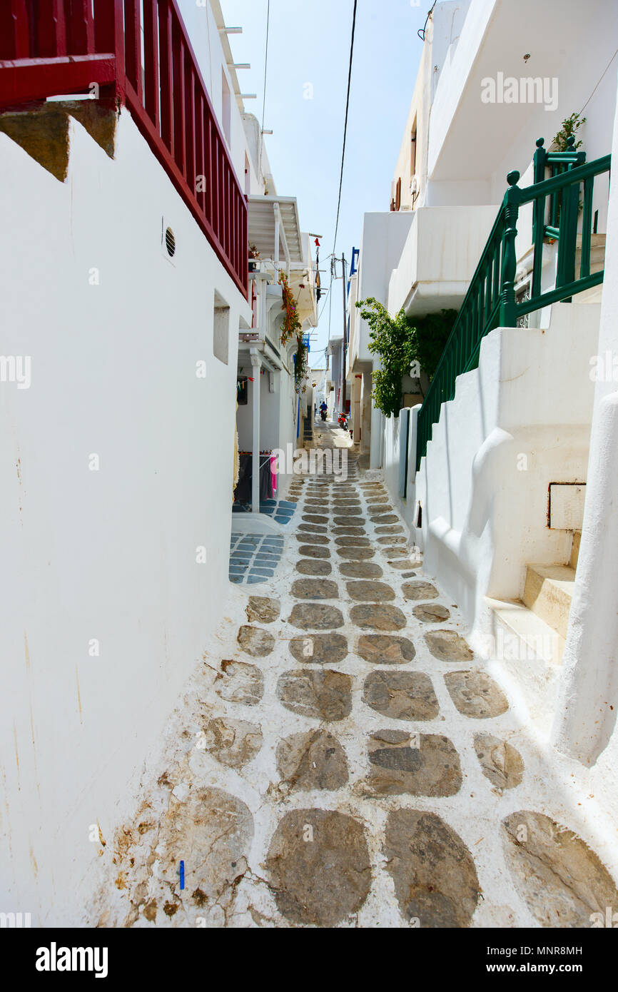 Typical street of greek traditional village with white walls and ...