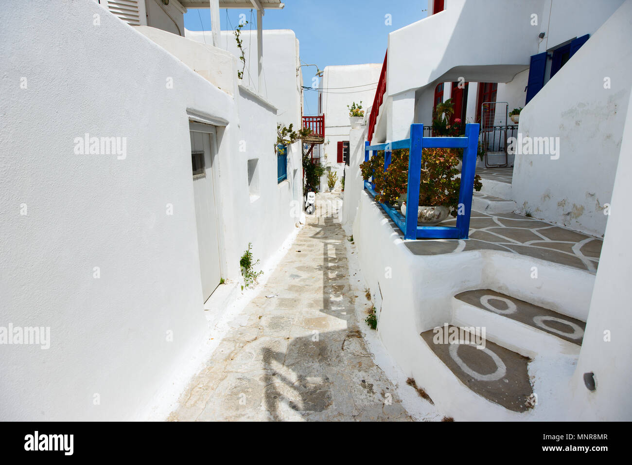 Typical street of greek traditional village with white walls and ...