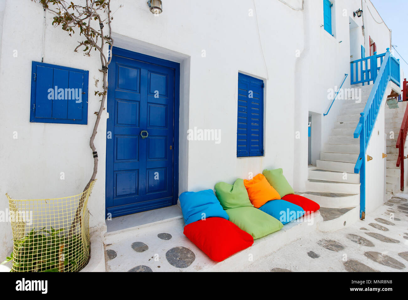 Typical greek traditional village with white walls and colorful doors ...