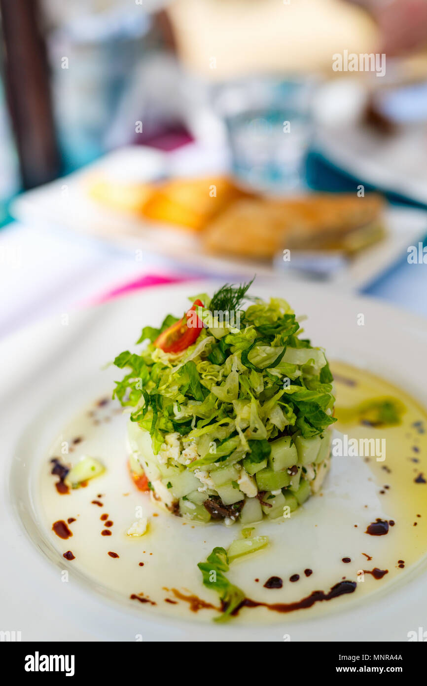 Delicious fresh Greek salad served for lunch at restaurant Stock Photo ...