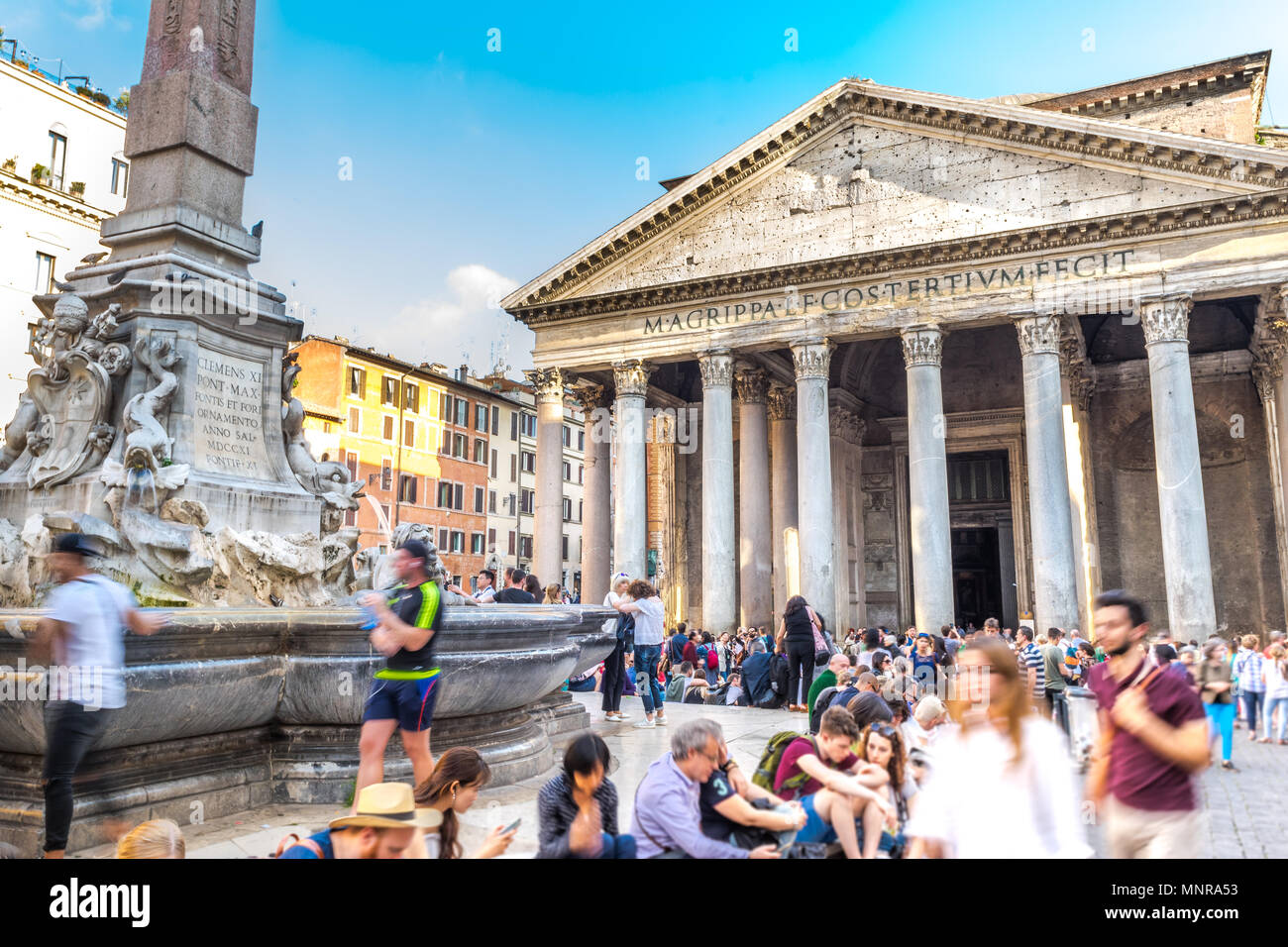The facade of the Pantheon in Rome with tourists walking around the ...