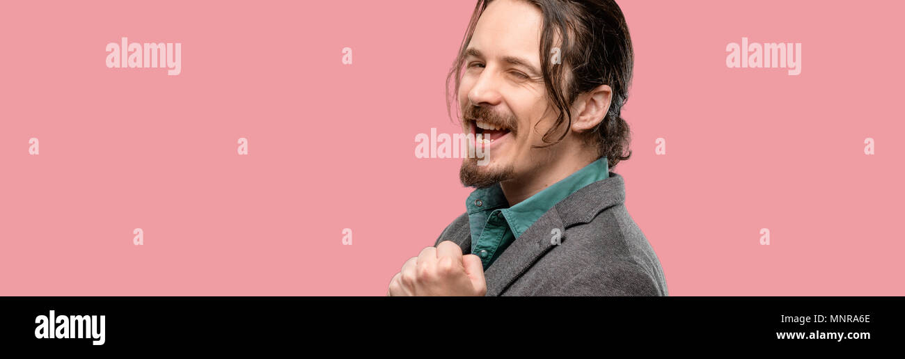 Handsome young man happy and excited expressing winning gesture ...