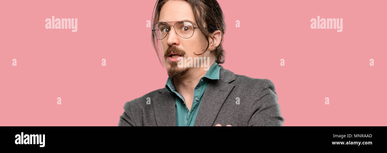 Handsome young man disgusted and angry, keeping hands in stop gesture ...